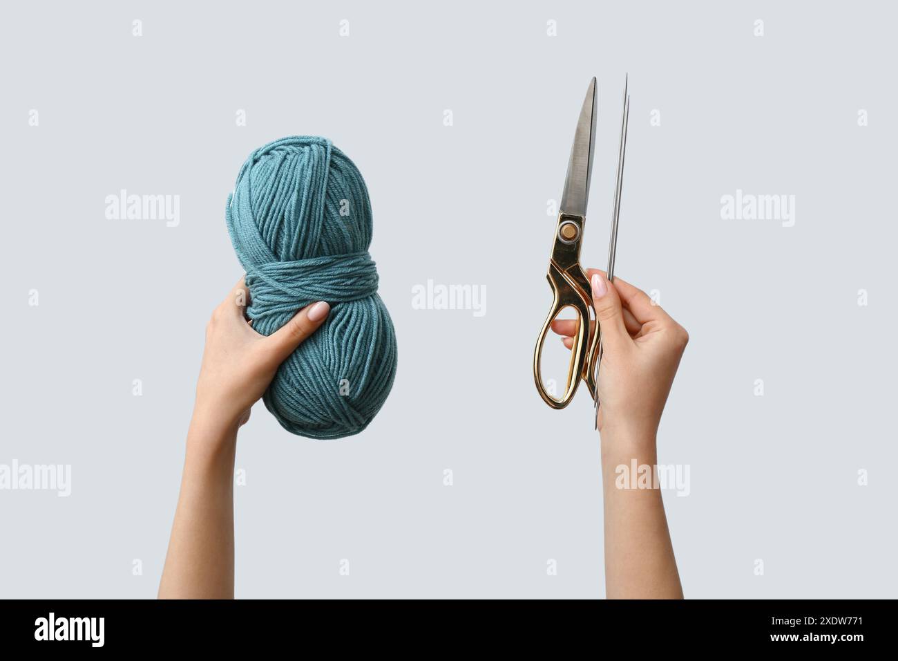 Woman holding scissors and yarn ball on white background Stock Photo ...