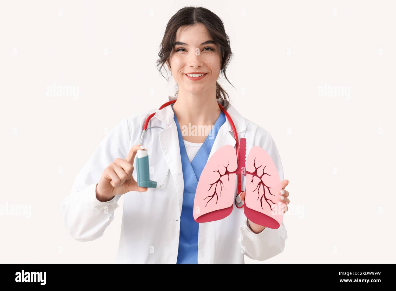 Female doctor with paper lungs and asthma inhaler on white background ...