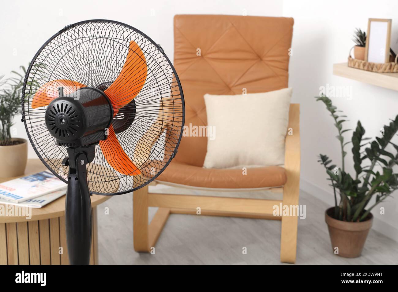 Electric fan on floor in living room Stock Photo - Alamy