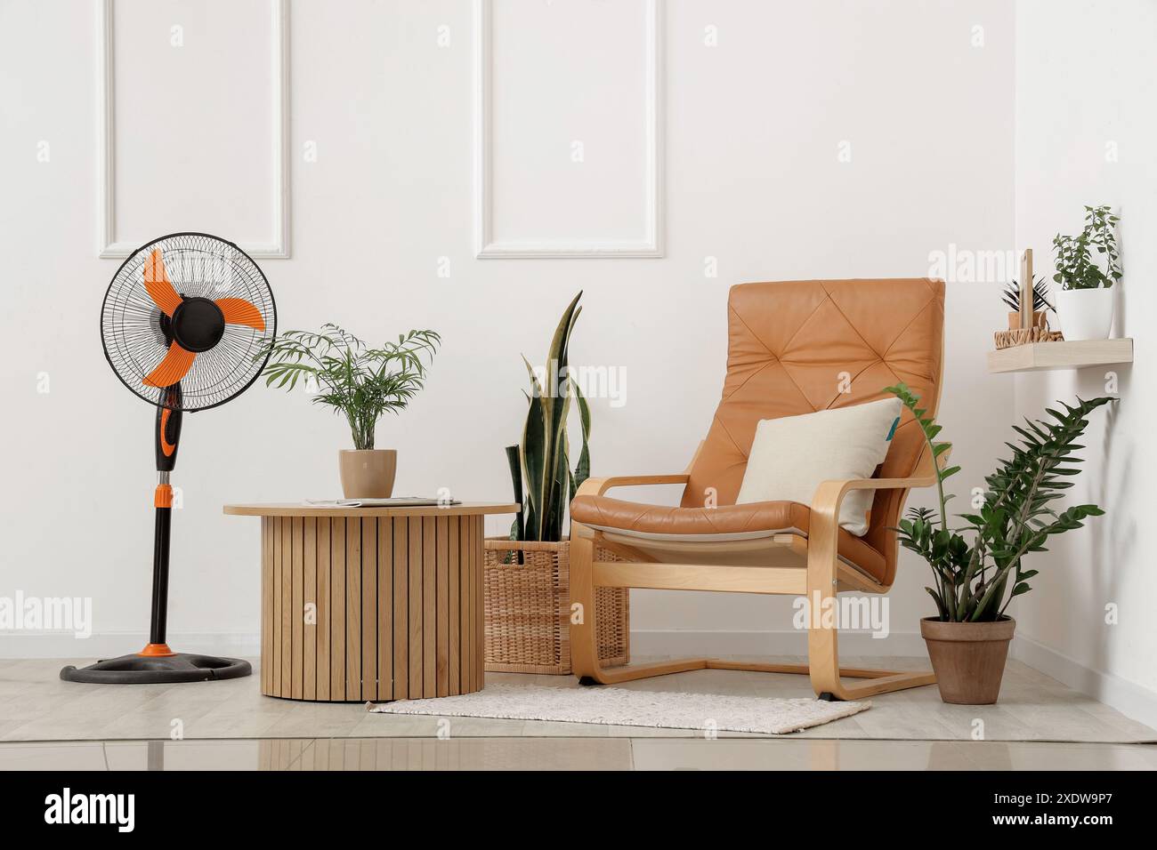 Electric fan on floor in living room Stock Photo - Alamy