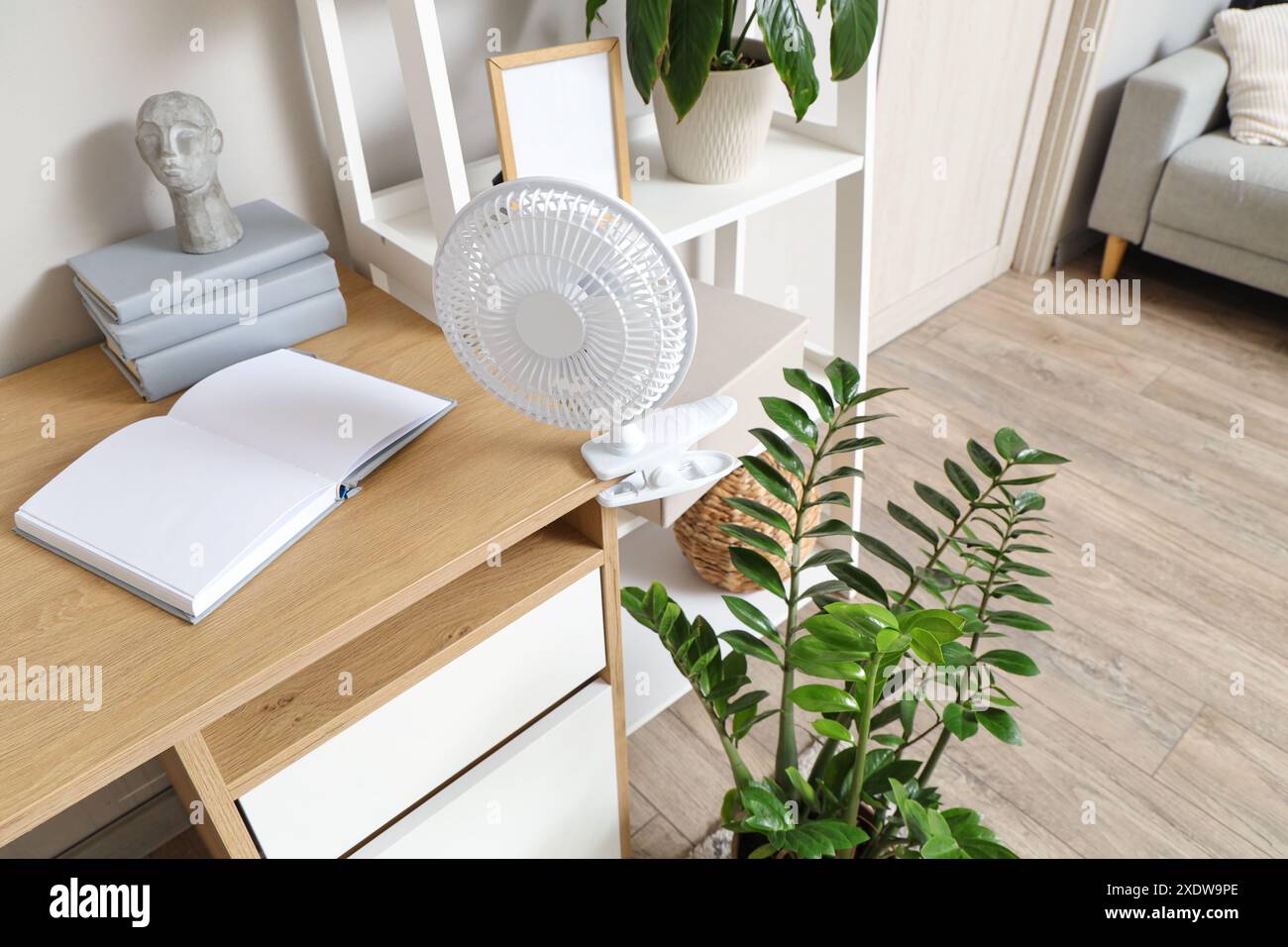 Electric fan on table at workplace Stock Photo - Alamy