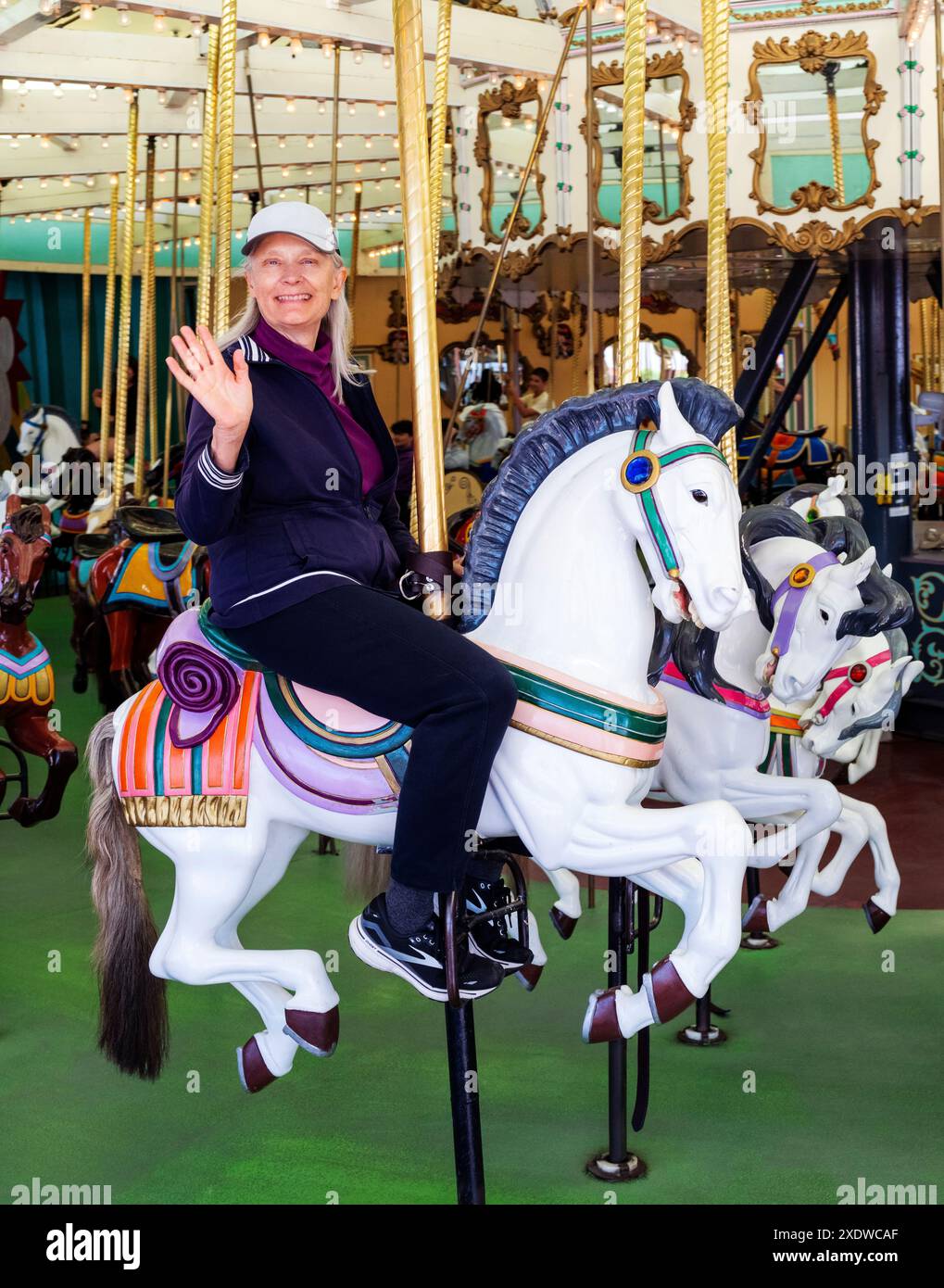 Lone senior female riding the 1911 Looff Carousel; National Historic ...