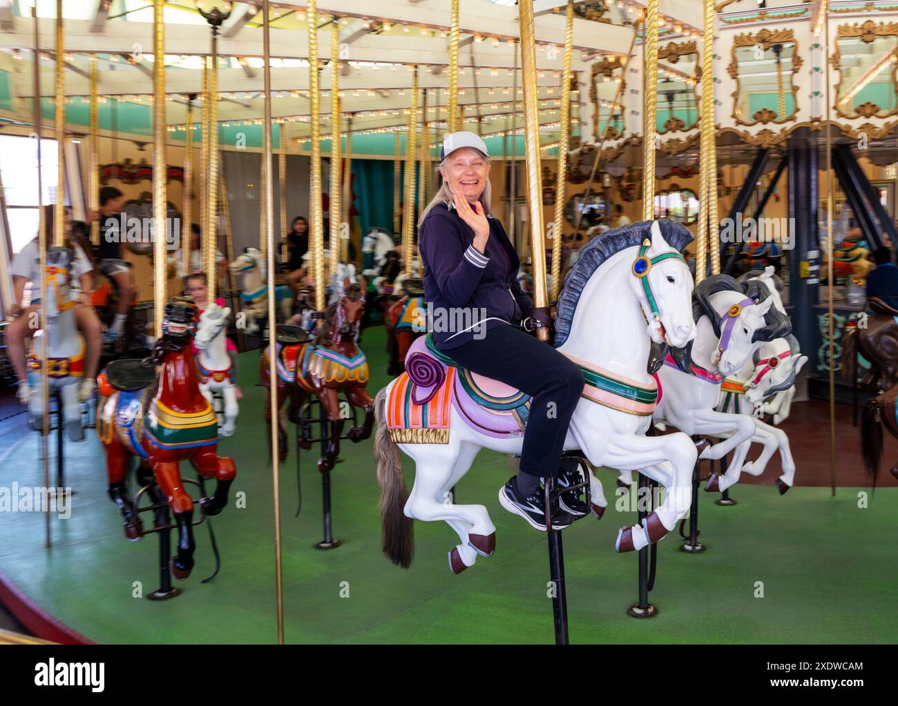 Lone senior female riding the 1911 Looff Carousel; National Historic ...