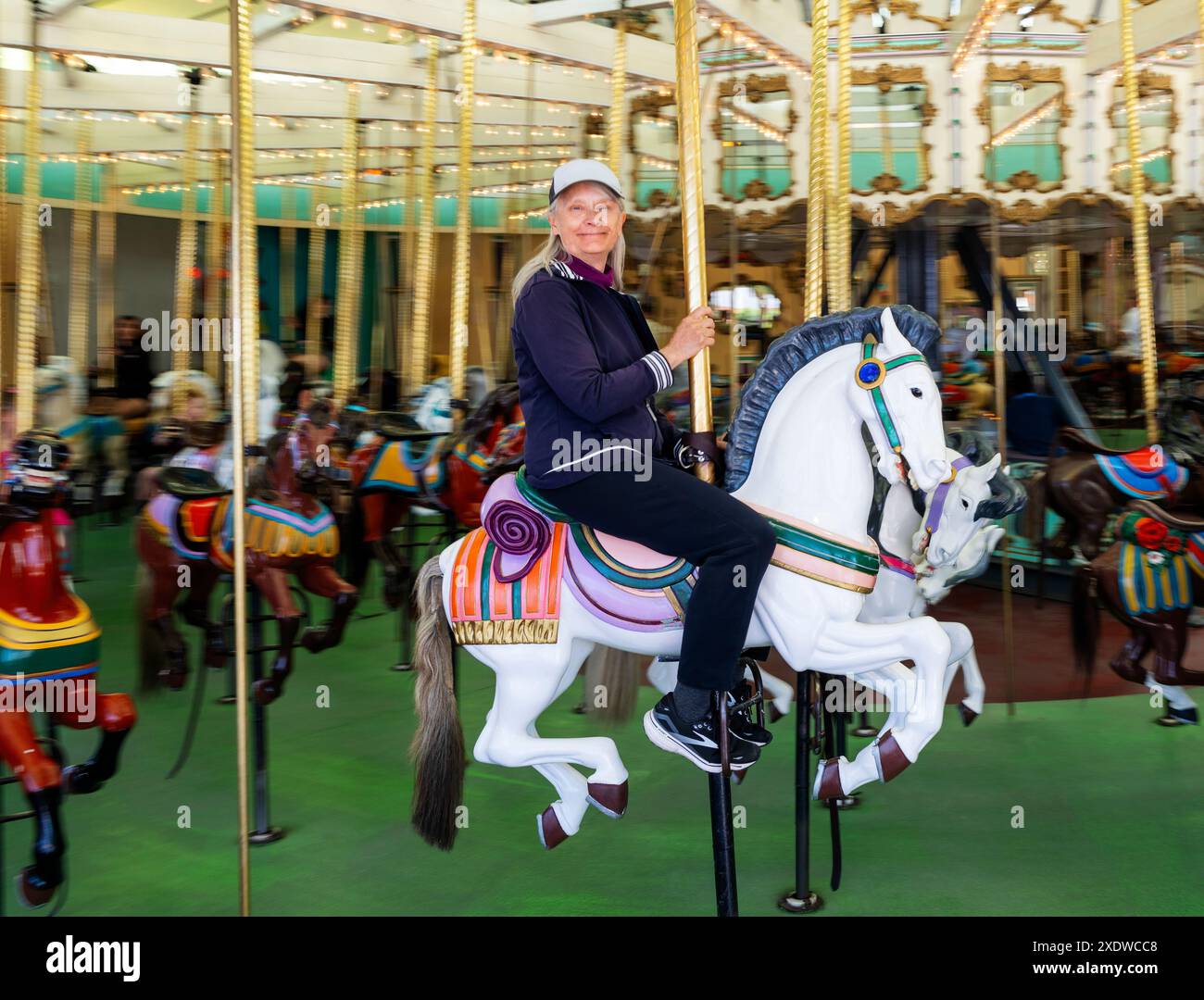 Lone senior female riding the 1911 Looff Carousel; National Historic ...