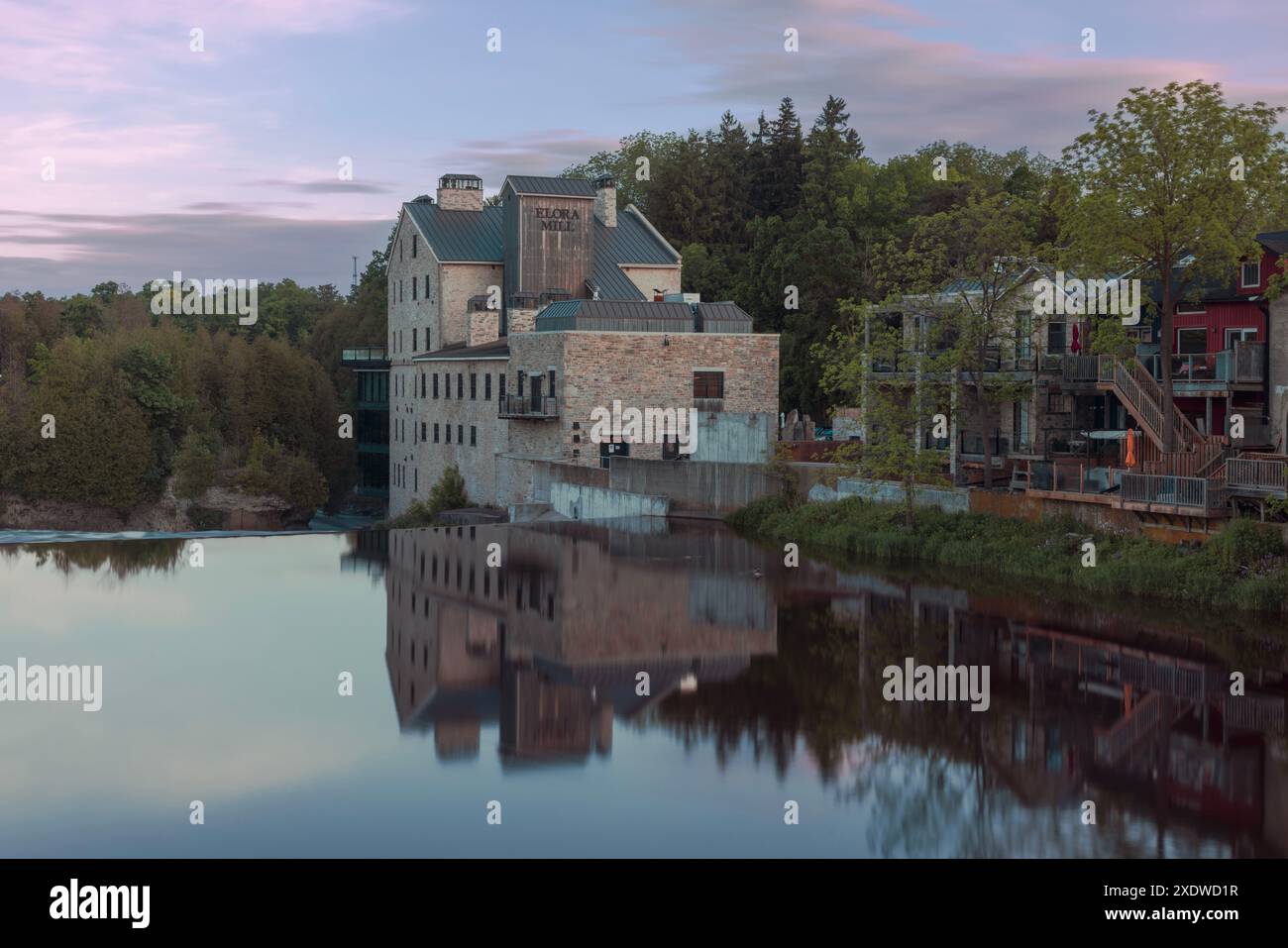 The historic Elora Mill, nestled in a gorge, overlooks the Grand River ...