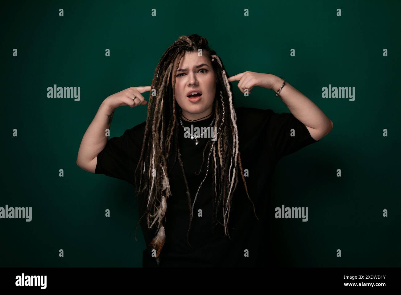 A woman with long dreadlocks is shown in the photograph, contorting her ...