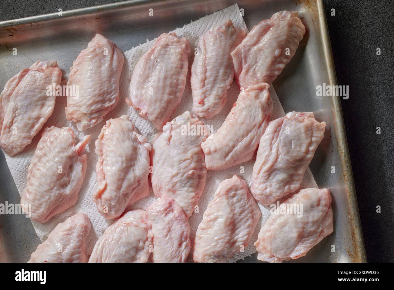 fresh raw chicken wings on grey kitchen table, top view. process of ...