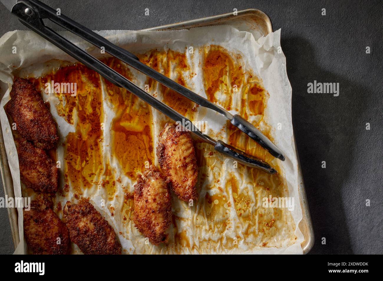 closeup of baked crispy spicy chicken wings on oven tray, top view ...