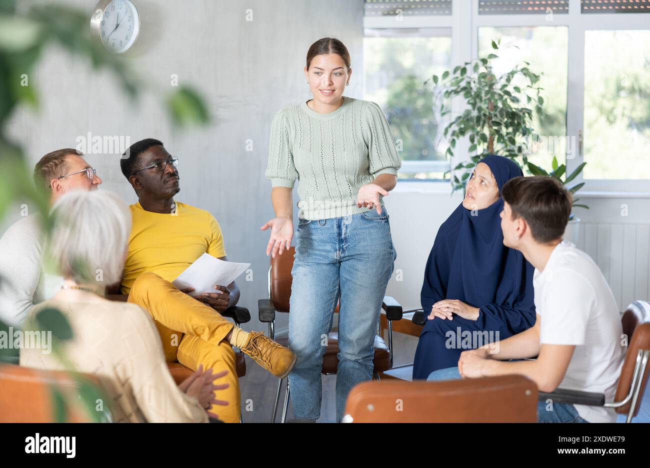 Woman tells an interesting story. Multinational students listening ...