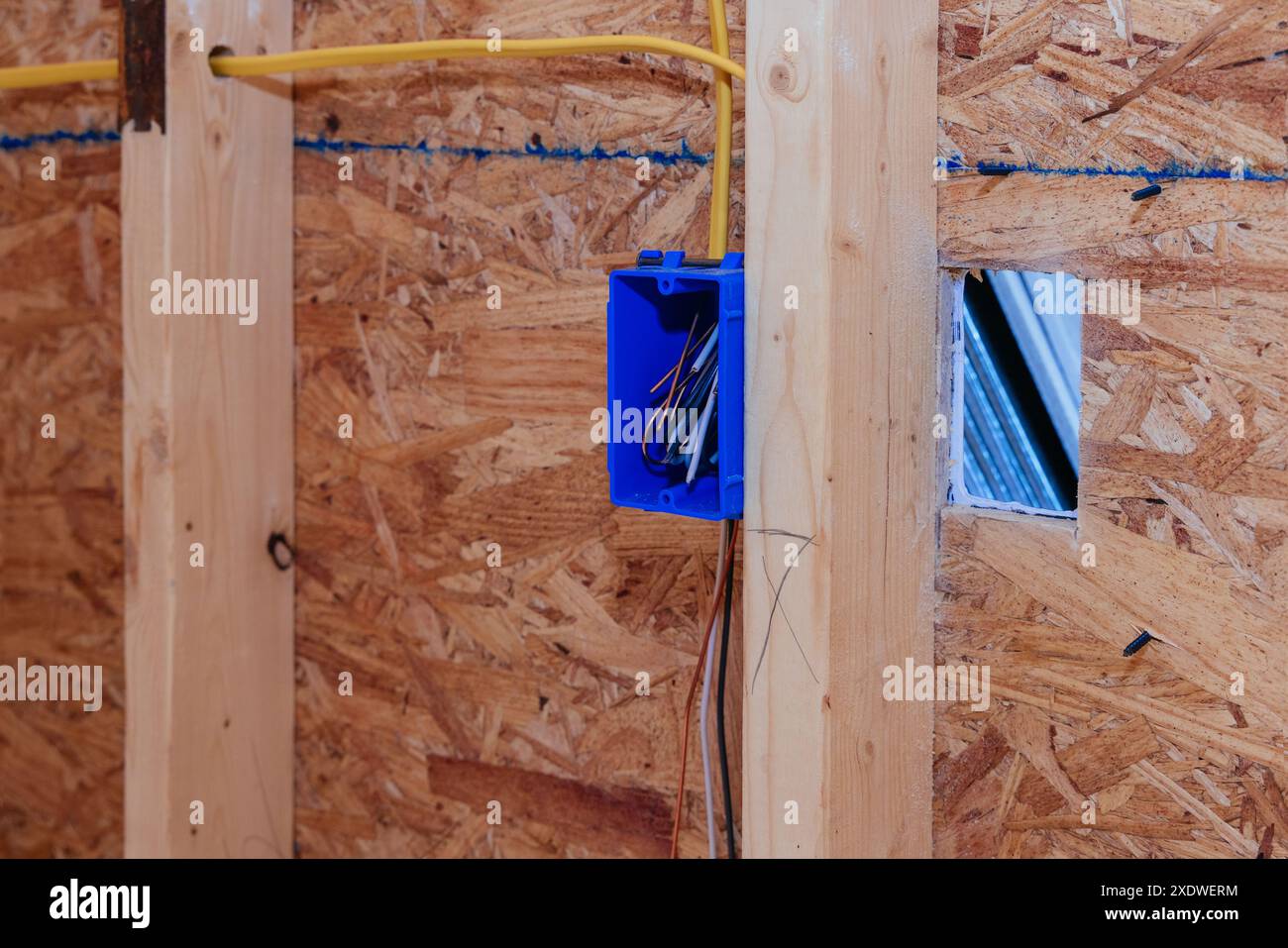 Installing mounting wiring in wall electric box for socket in new house ...