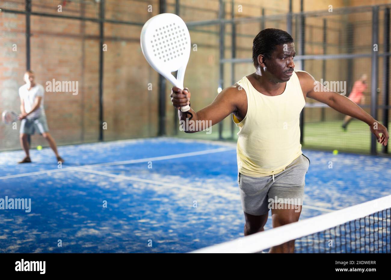 Padel tennis player posing in court closeup Stock Photo - Alamy