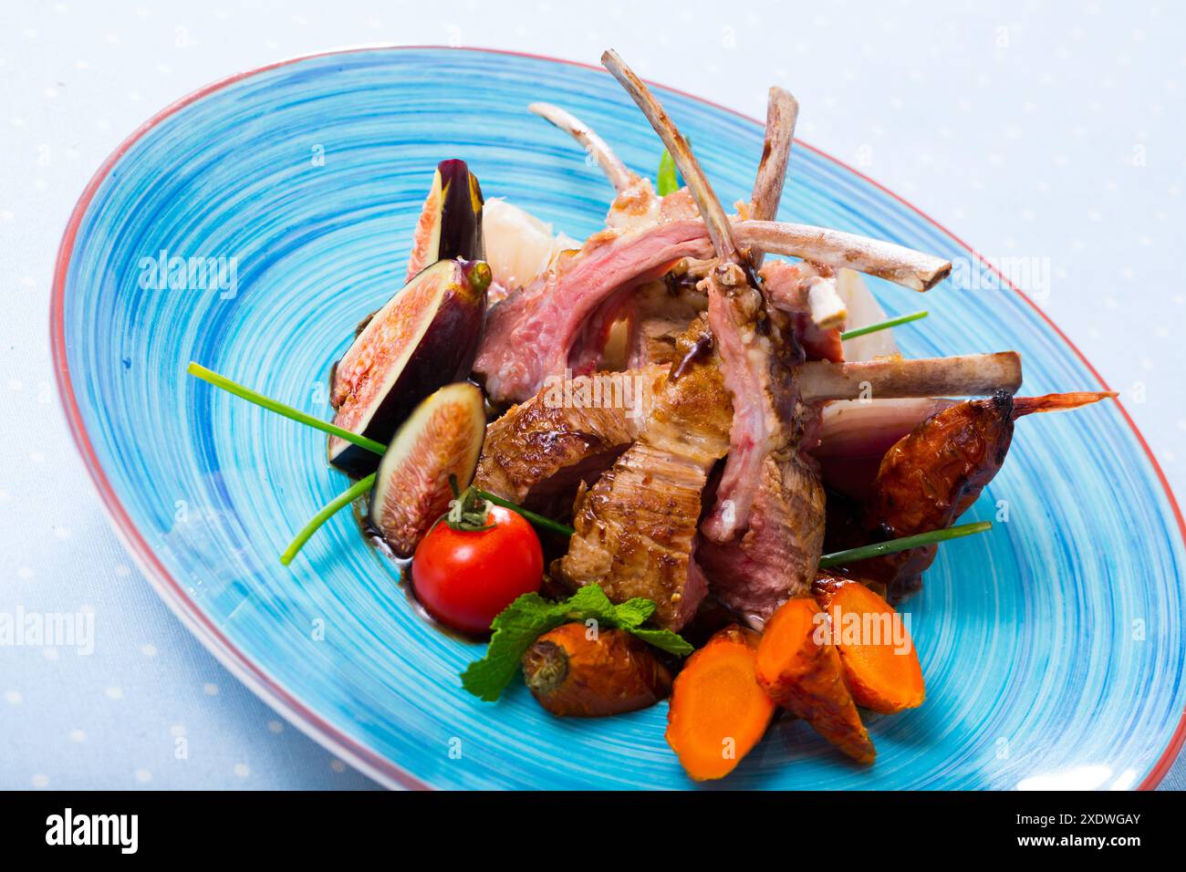 Baked ribs of lamb with vegetables, figs, sauce demi-glace Stock Photo ...