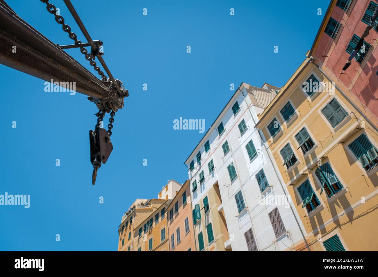 Colorful buildings and antique crane in Camogli, Italy Stock Photo - Alamy