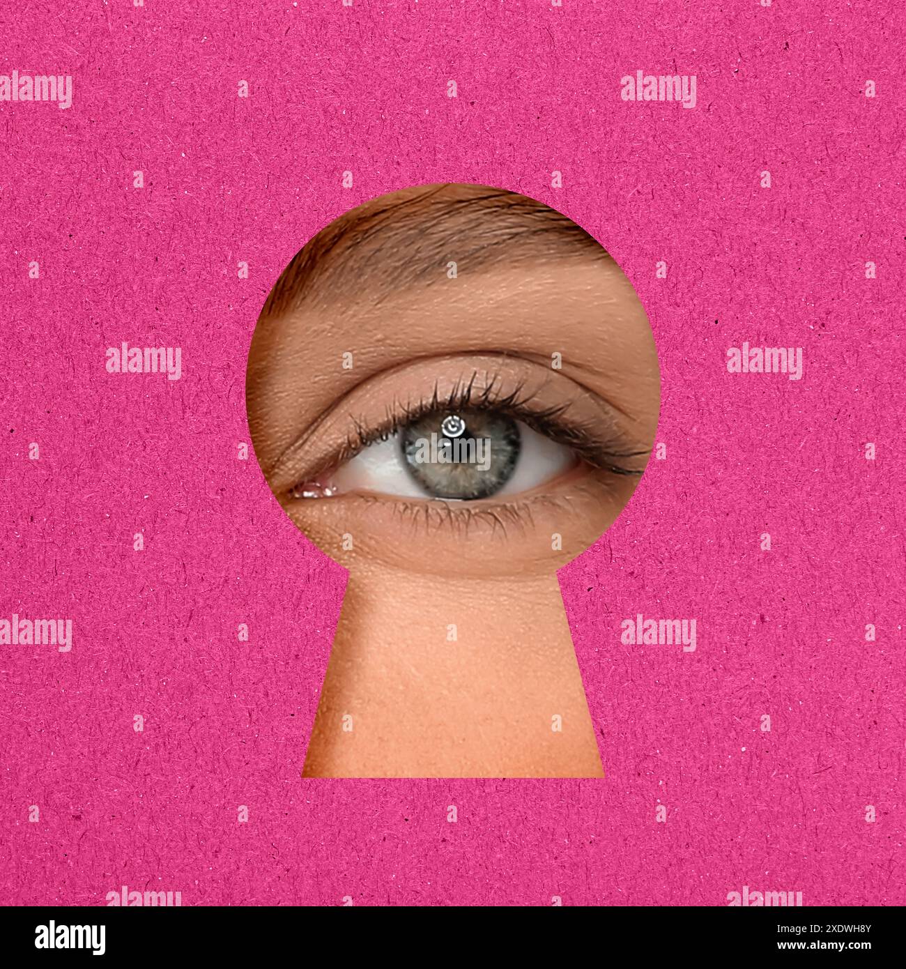 Woman looking through keyhole in pink surface Stock Photo - Alamy