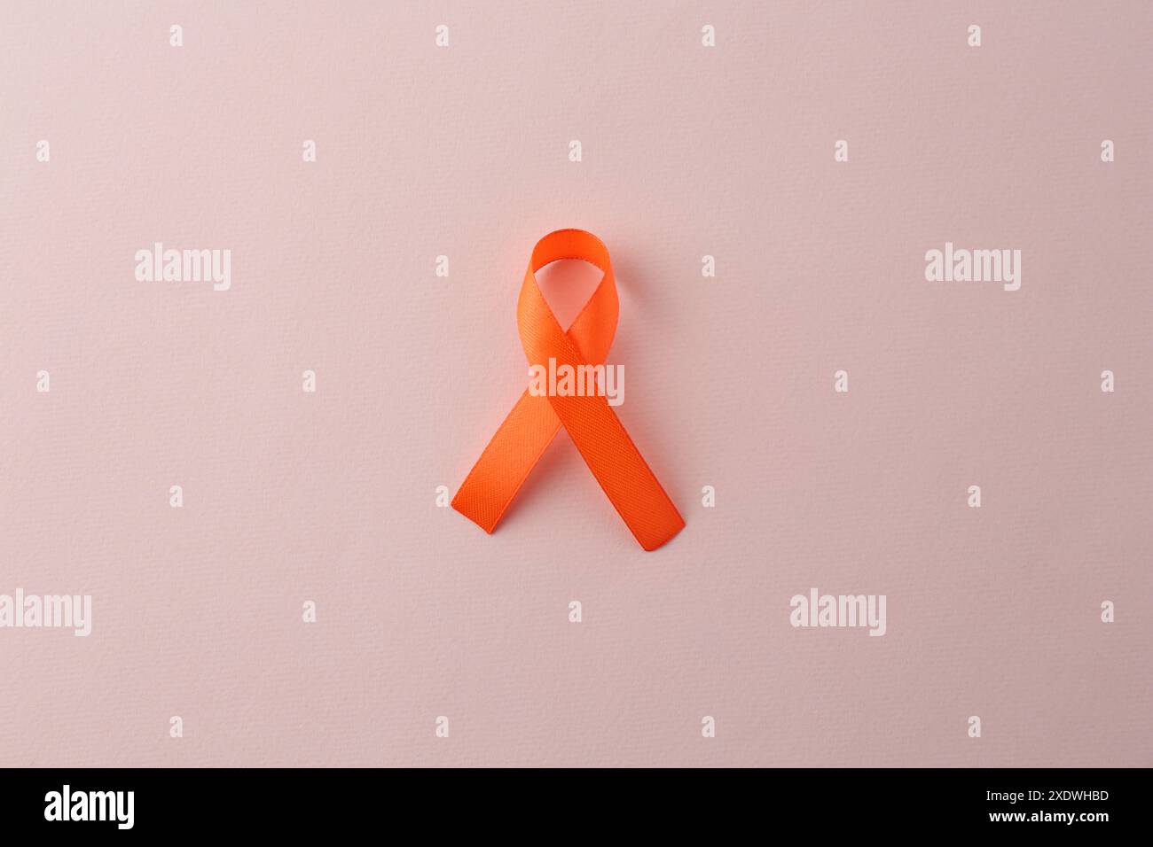 Orange awareness ribbon on beige background, top view Stock Photo - Alamy