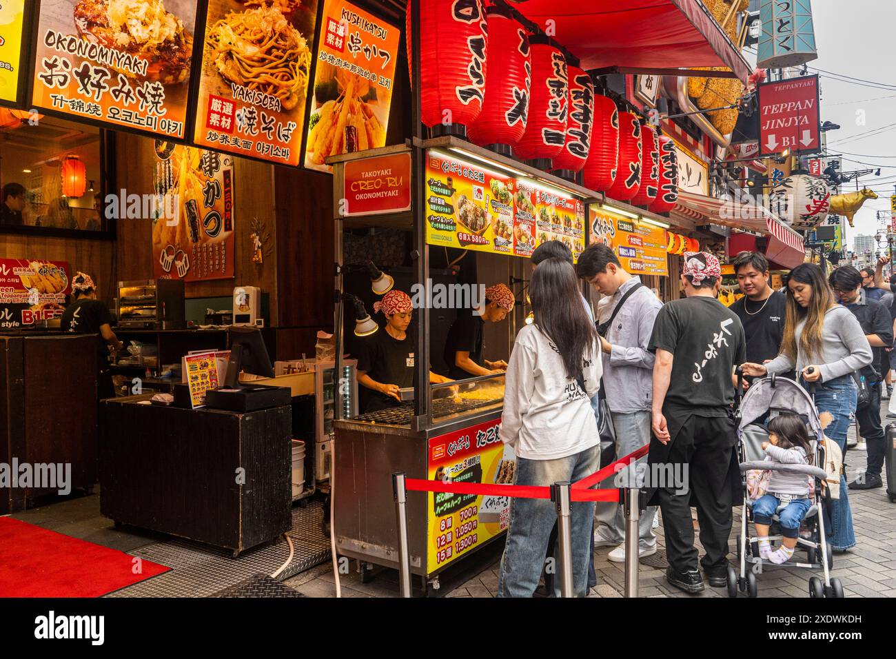 Osaka Japan people eating street food Stock Photo - Alamy