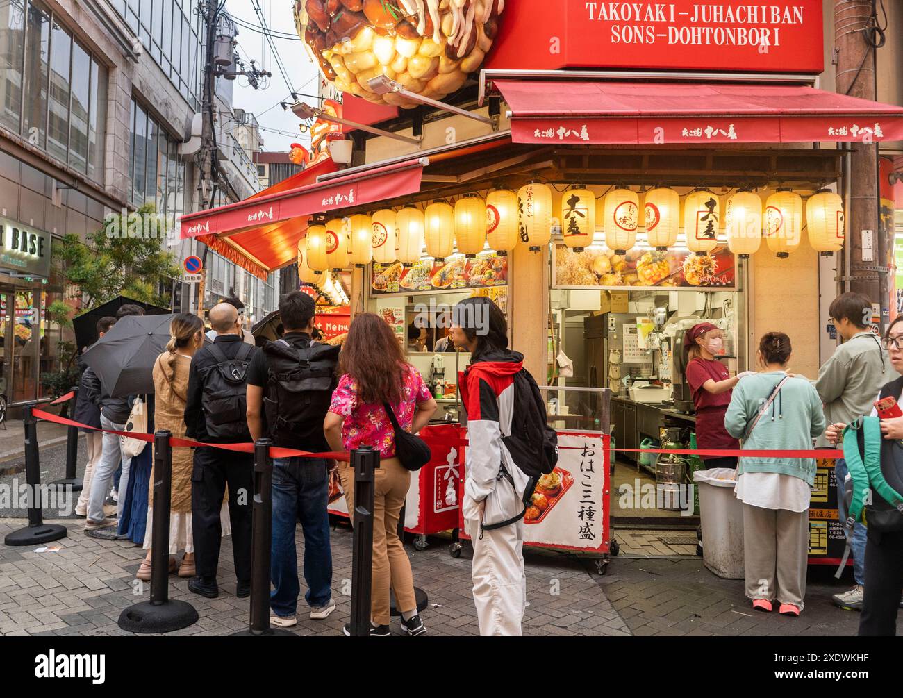 Osaka Japan people line up queue food eating street Dotonbori Stock ...