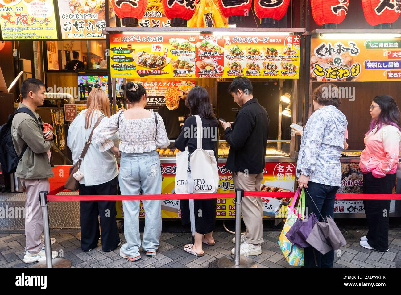 Osaka Japan people line up queue food eating street Dotonbori Stock ...