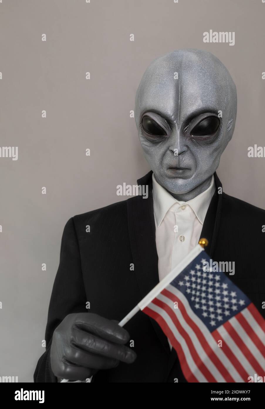 Extra Terrestrial Being, Portrait Of Alien Wearing Suit And Holding ...
