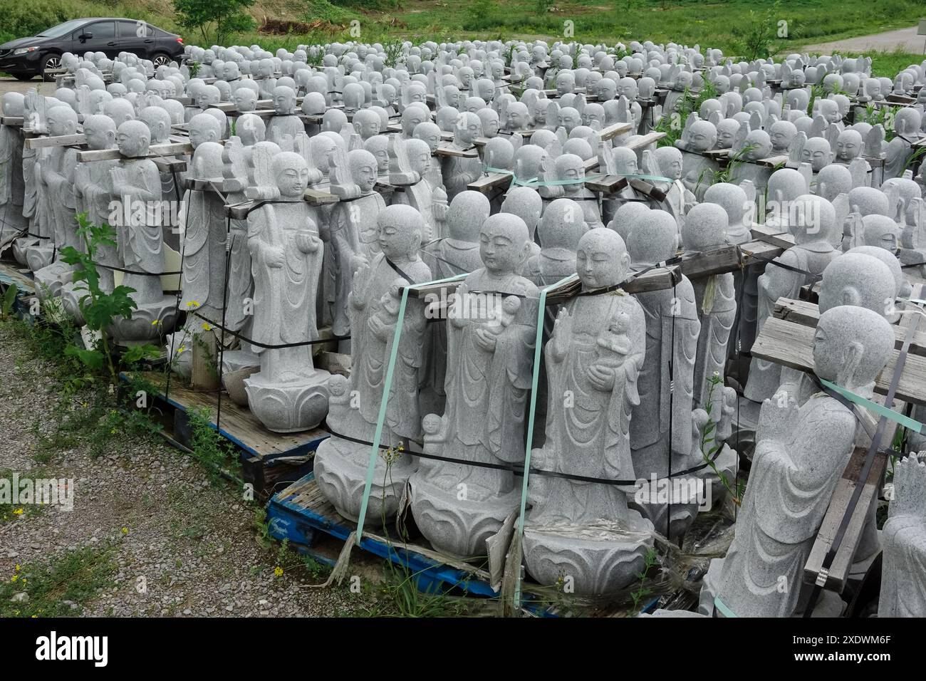 many buddhist stone carved statues packed ready for moving Stock Photo ...
