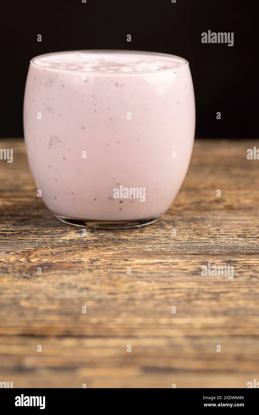 pink fermented milk drink with berry flavor, pieces of berries and ...