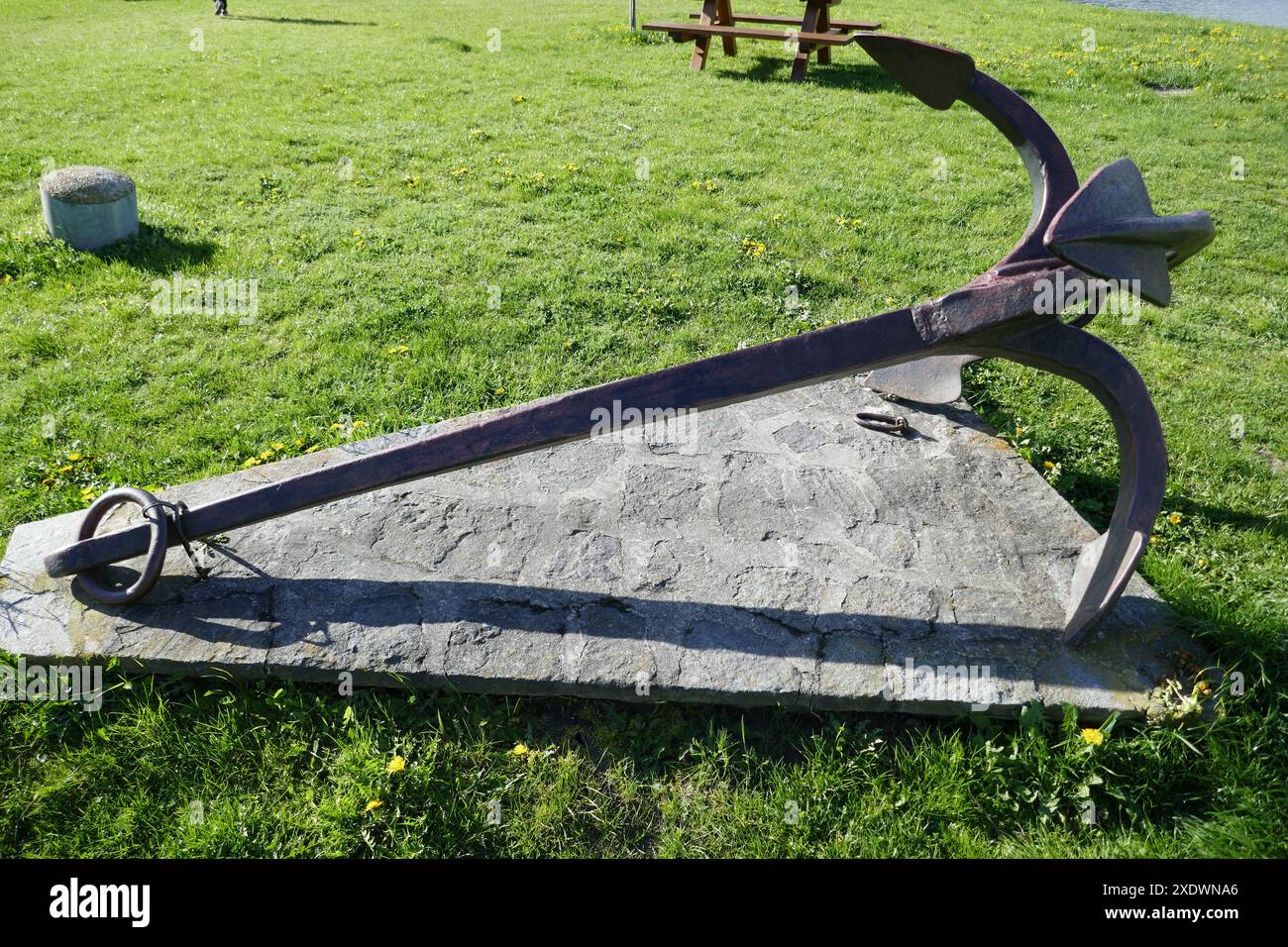 Old metal ship anchor displayed outside in public park Stock Photo - Alamy
