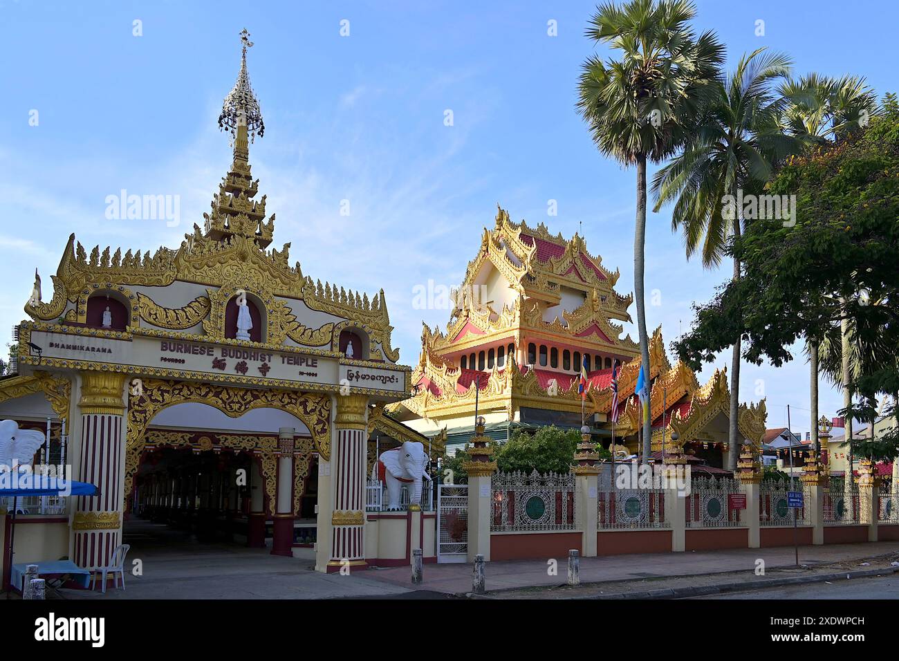 Ornate golden red entrance arch and facade of the the Dhammikarama ...