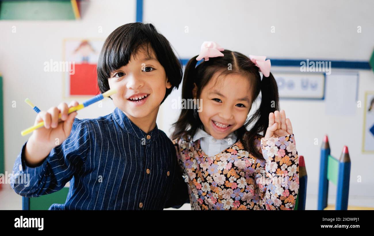 Happy Asian children having fun at kindergarten school room. Friendship ...