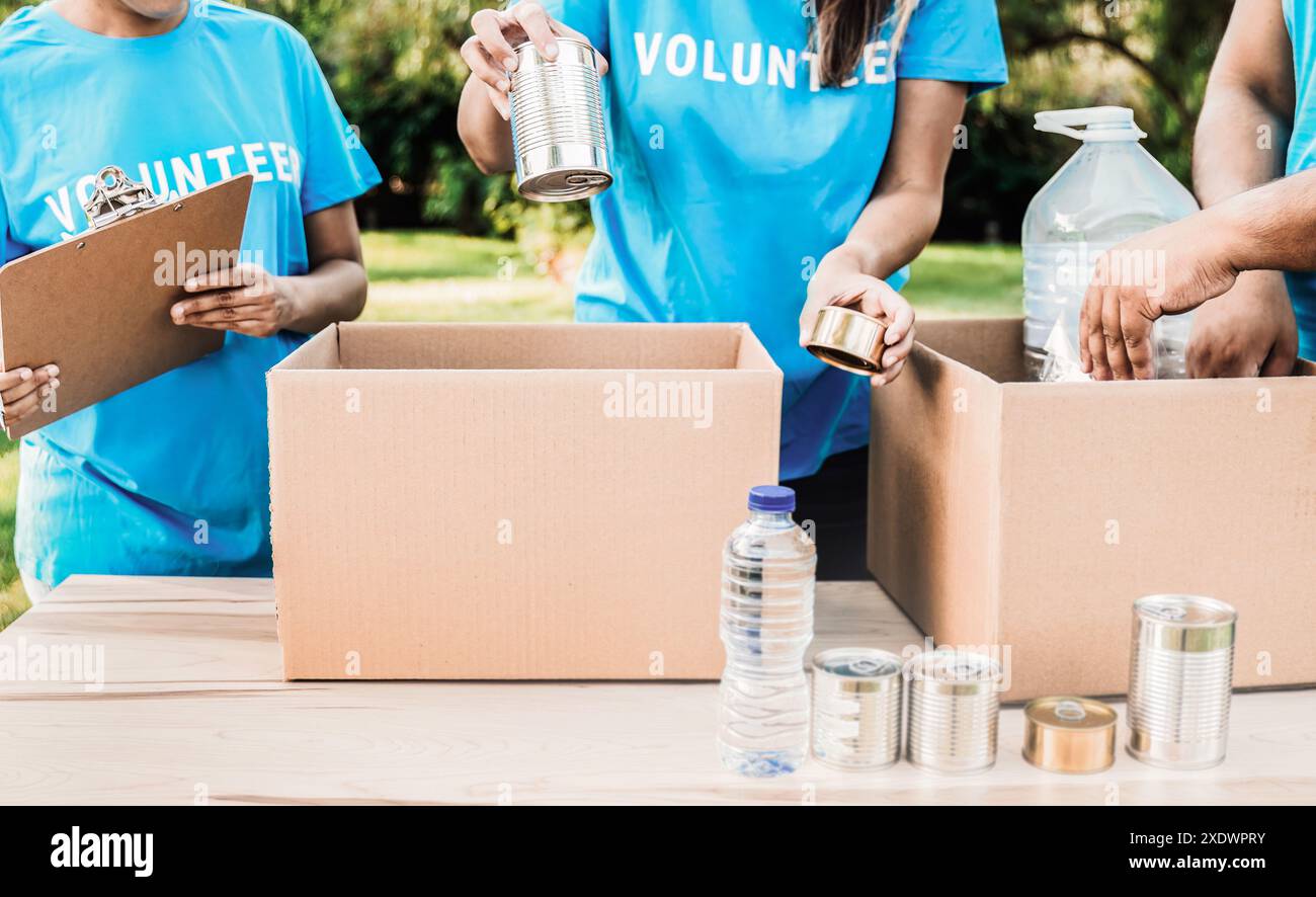 Team of volunteers work collecting goods and food for community service ...
