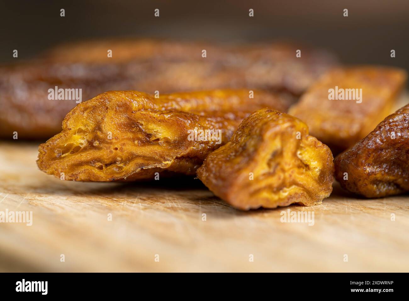 small dried bananas on a board, dried fruits made from dehydrated but ...