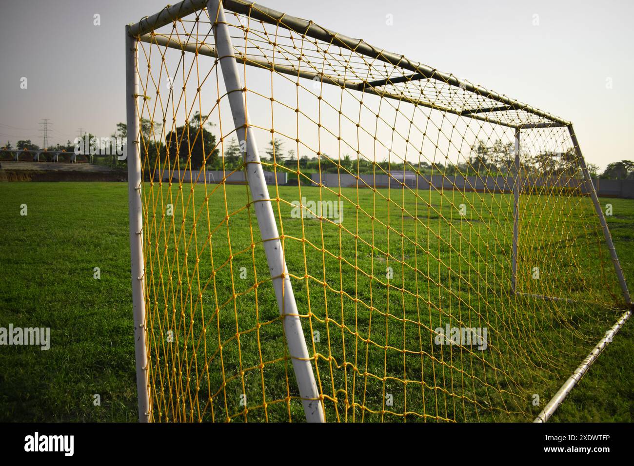 Football goal in the football field in the morning with a sunset ...