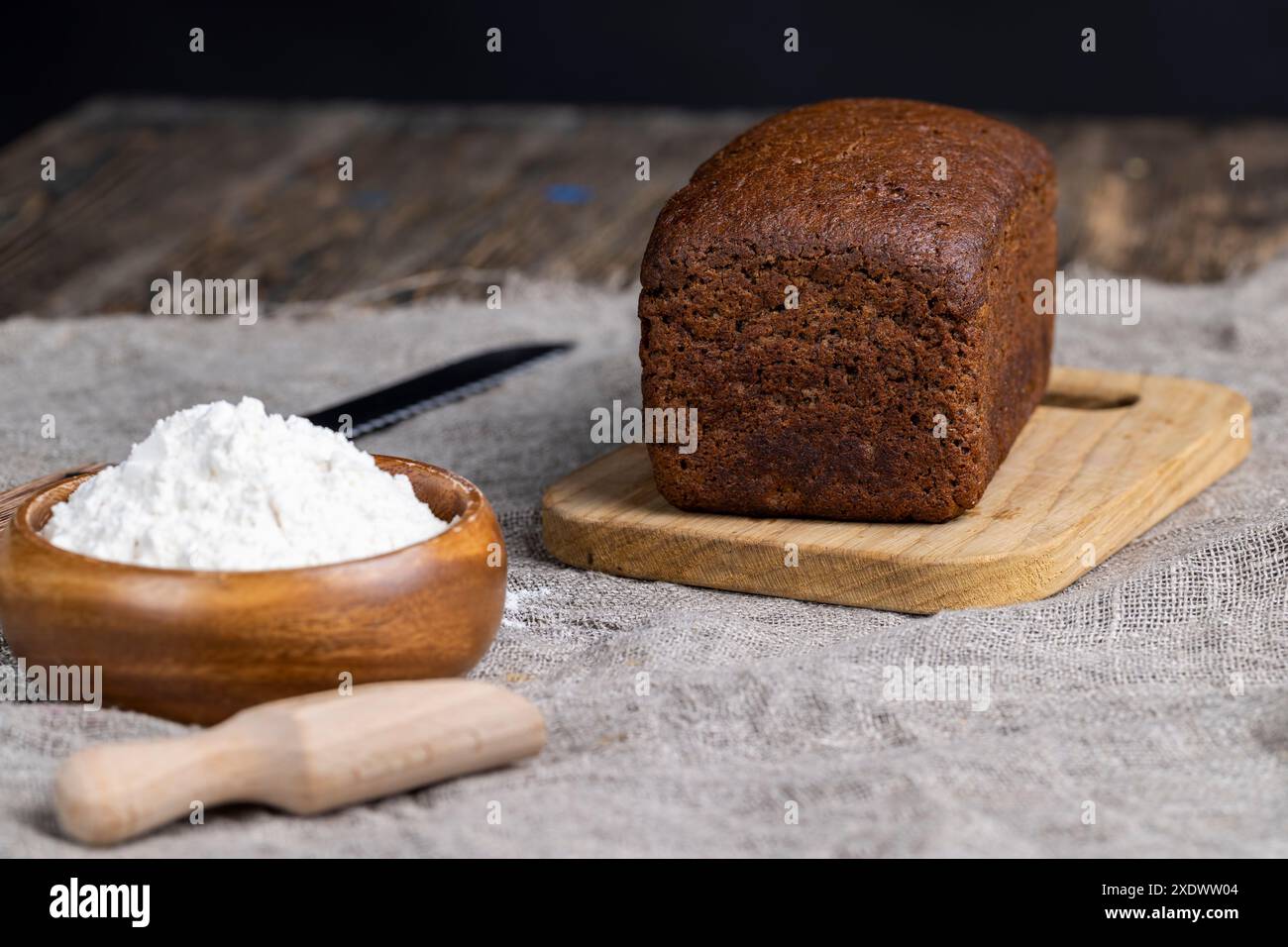 a loaf of rye black bread made from rye and wheat flour, a square dark ...