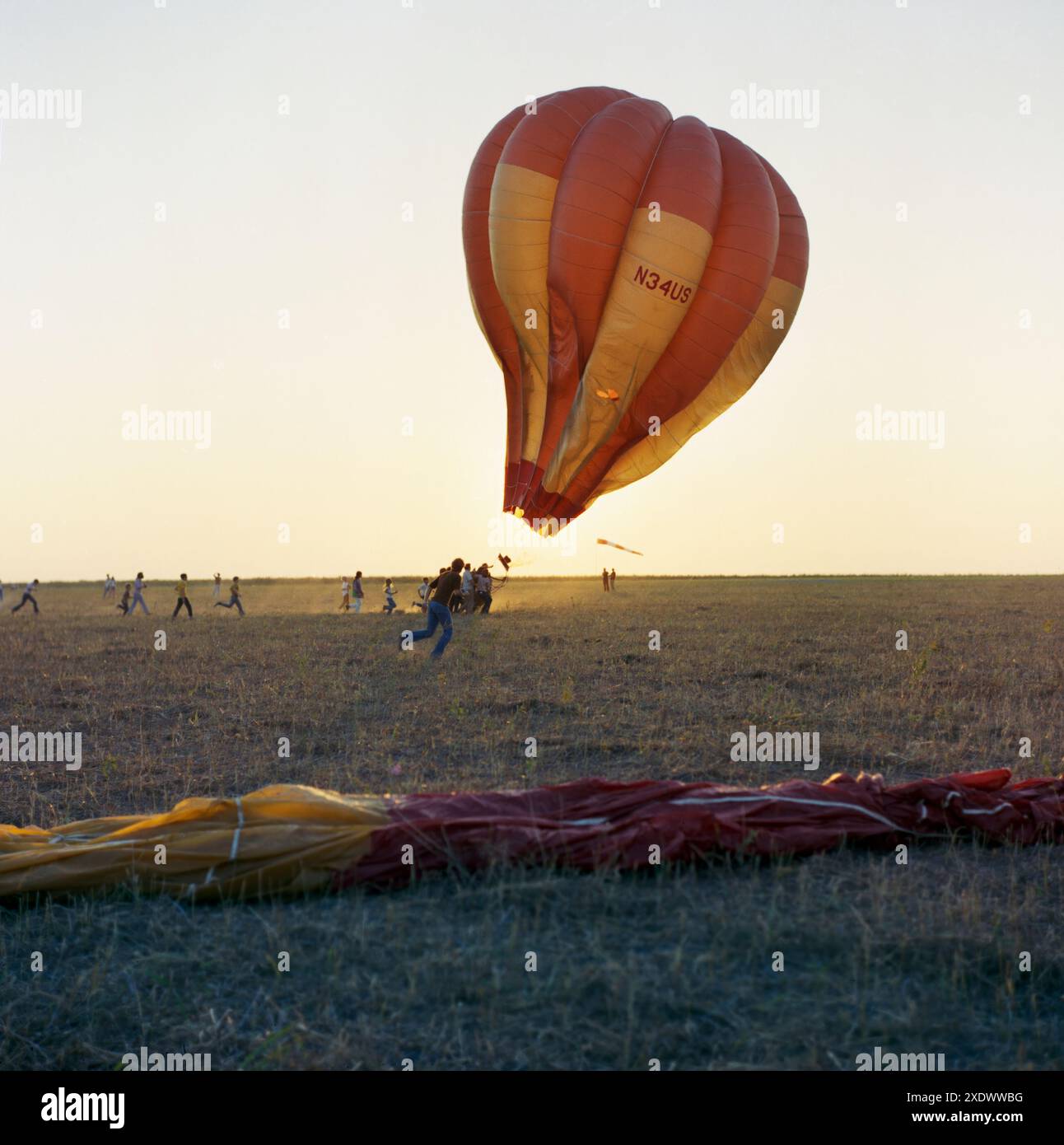 Chasing a hot air balloon on the ground Stock Photo - Alamy