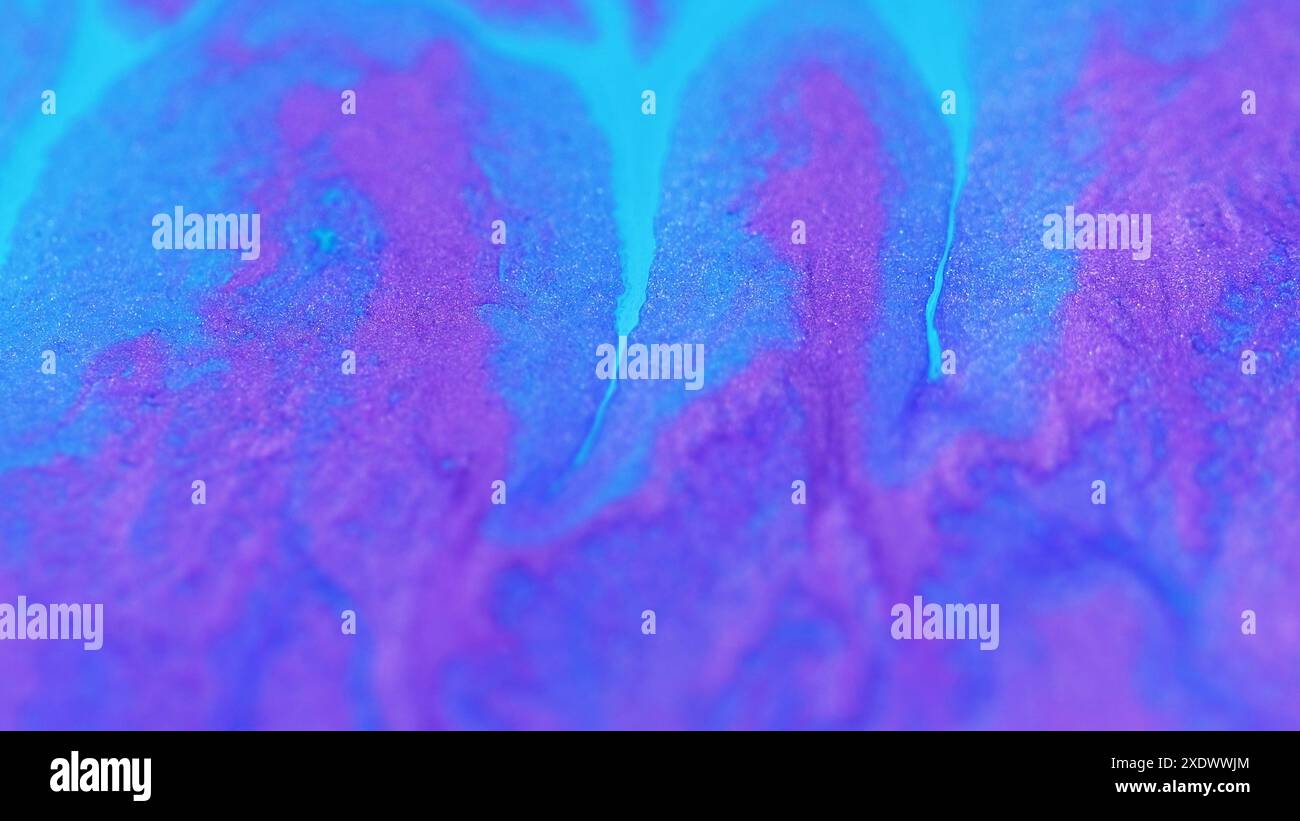 Ink spill. Liquid glitter texture. Defocused neon blue purple color ...