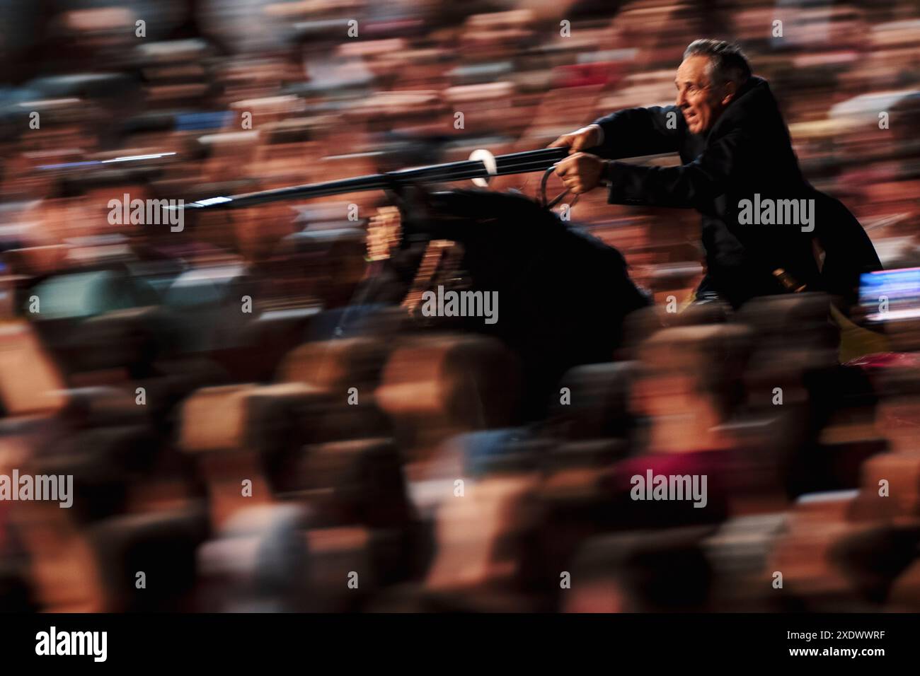 Ciutadella, Spain. 24 June, 2024: A 'caixer' (horseman) aims his spear ...