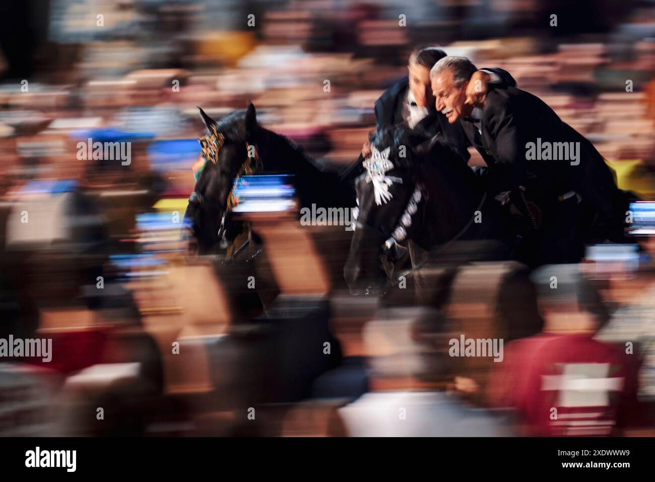 Ciutadella, Spain. 25 June, 2024: Two 'caixers' (horse riders) gallop ...