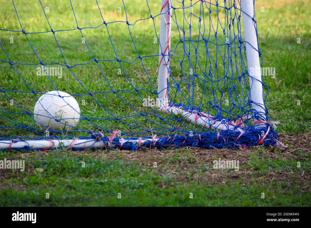 Soccer ball in goal. Football goal in the football field with sunlight ...