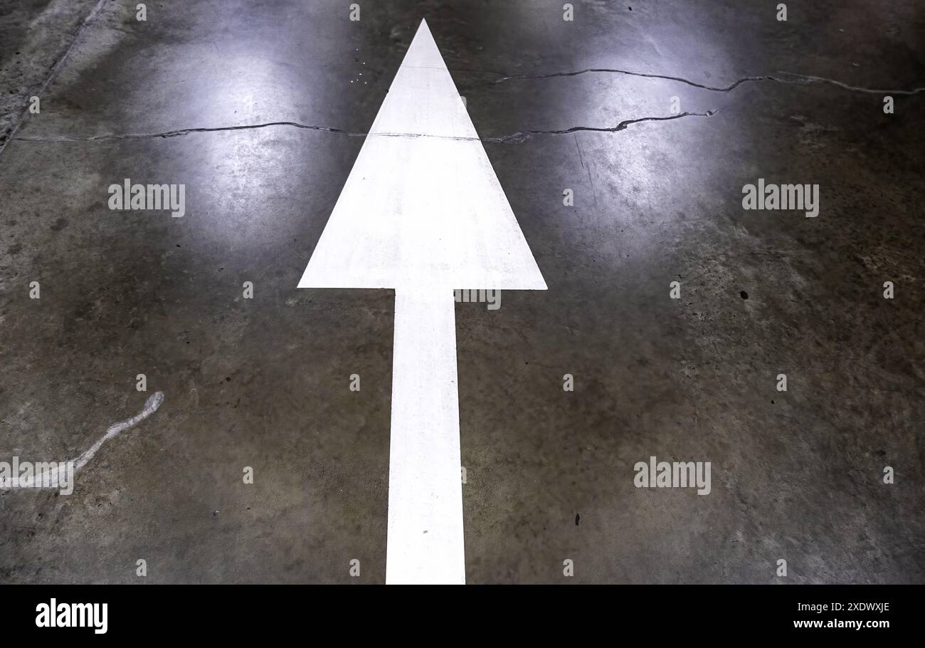 Detail of direction arrow for vehicles in a parking lot Stock Photo - Alamy
