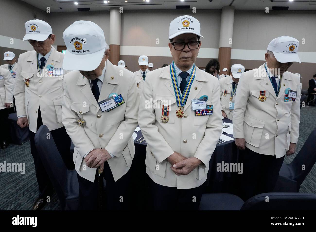 Korean War veterans pay a silent tribute at a condolence event for war ...
