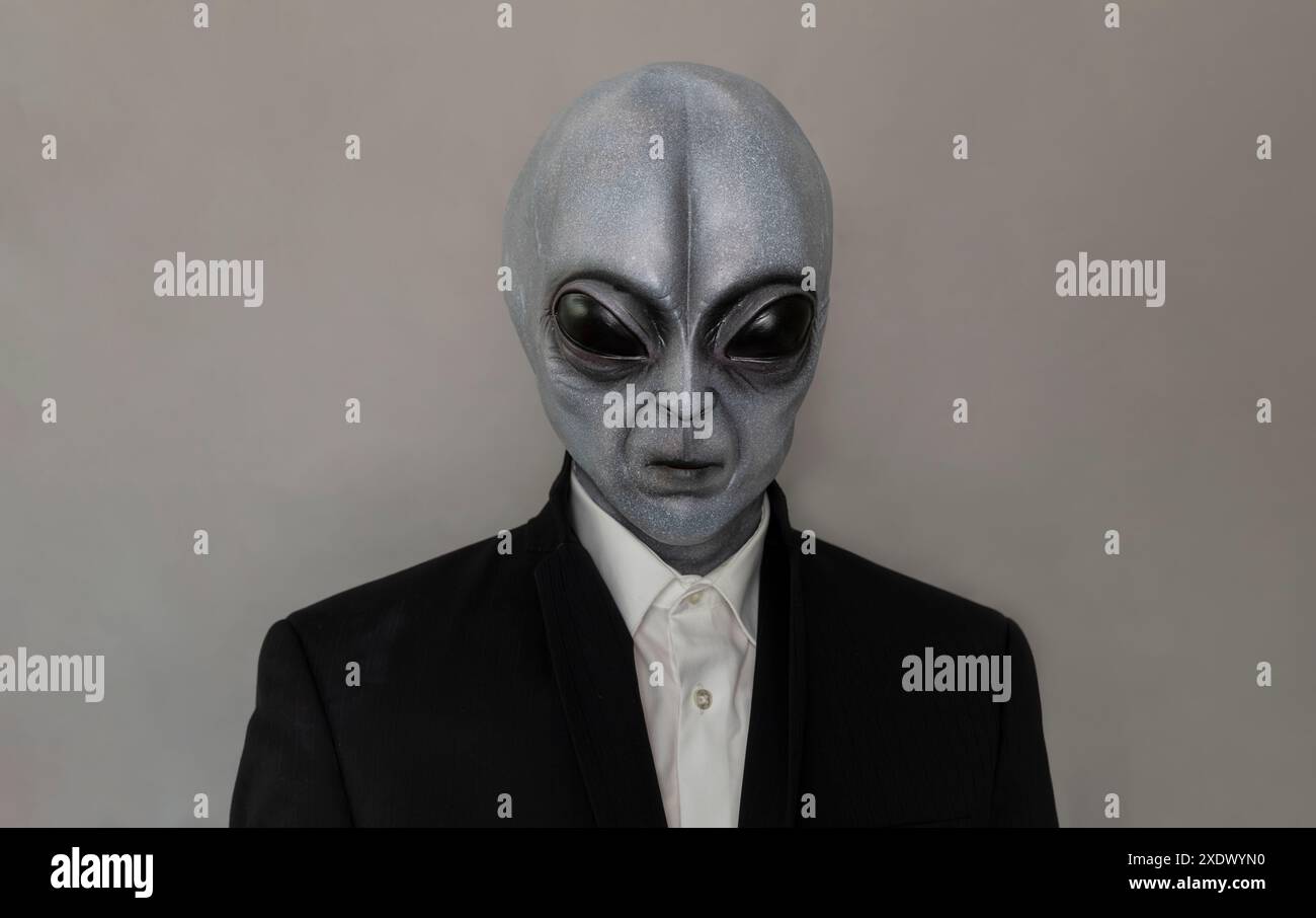 Portrait Of Alien Wearing Suit Gray Background. World UFO Day. Extra ...