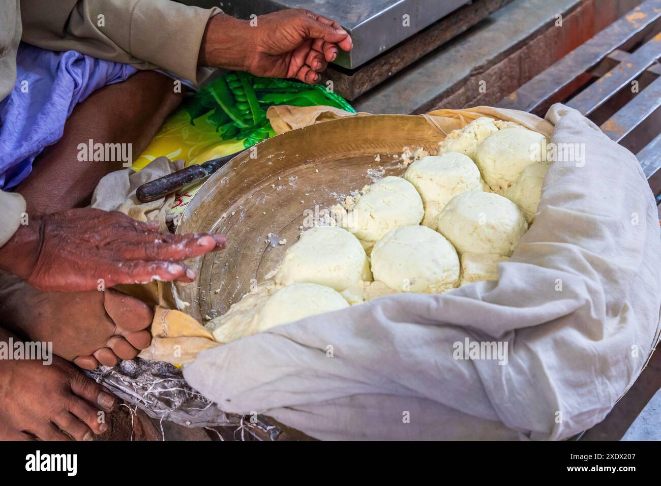 India, Uttar Pradesh, Varanasi, Lahori Tola. Preparing balls of chhena ...