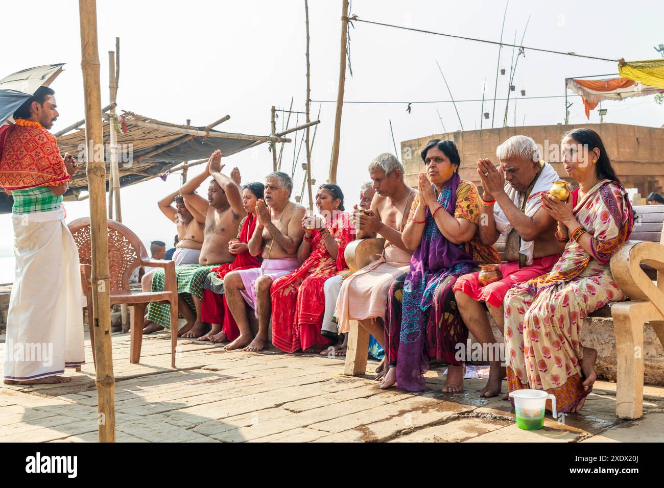 India, Uttar Pradesh, Varanasi, Ghasi Tola. People praying together ...