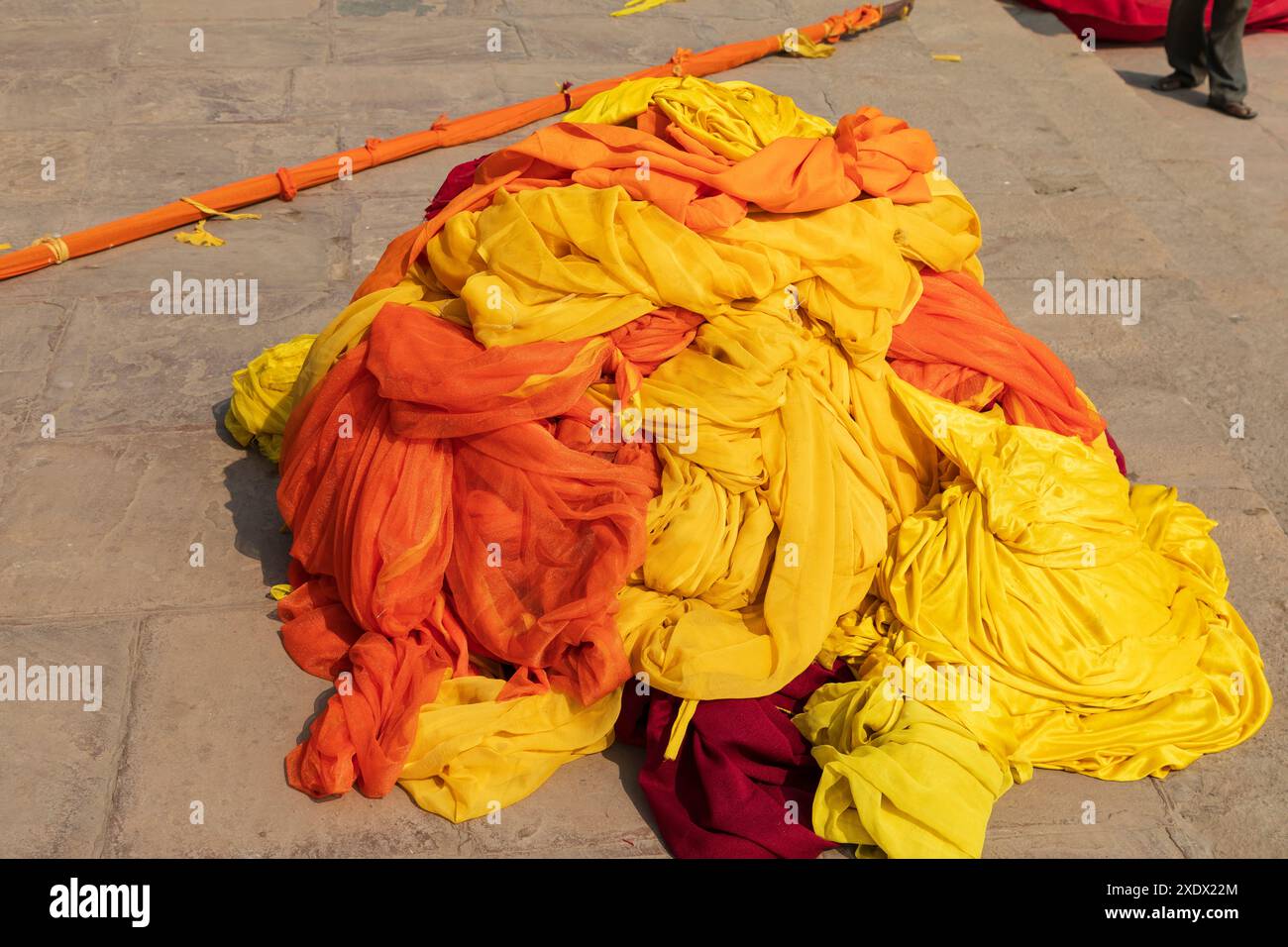 India, Uttar Pradesh, Varanasi, Ghasi Tola. Saffron-colored fabrics ...
