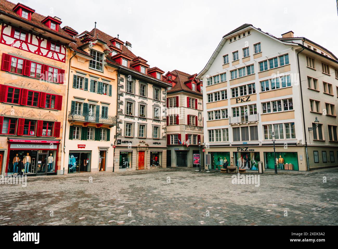 Colorful buildings and shops on a cobblestone street in Lucerne ...