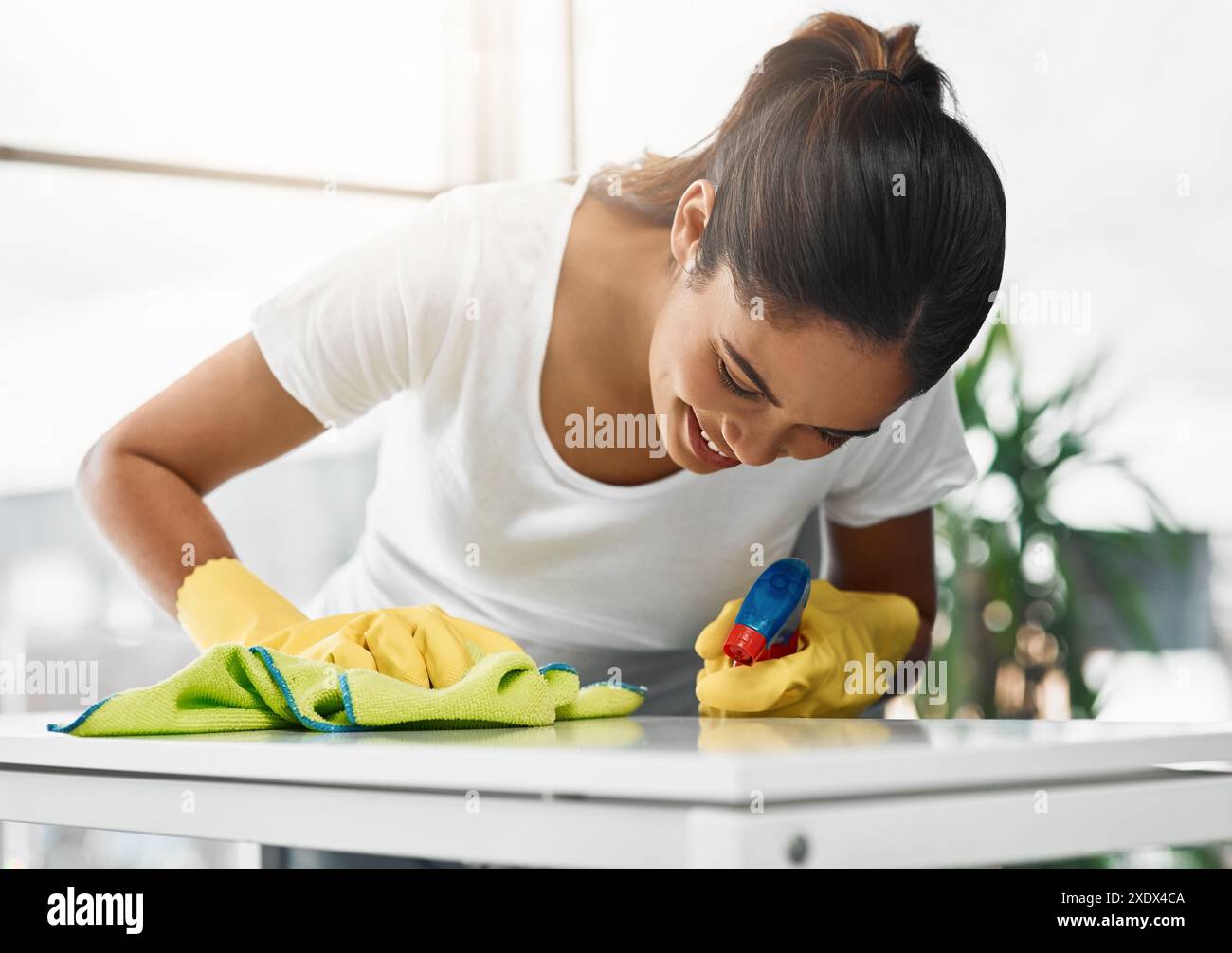 Woman, cleaning and spray detergent on kitchen counter for disinfect ...
