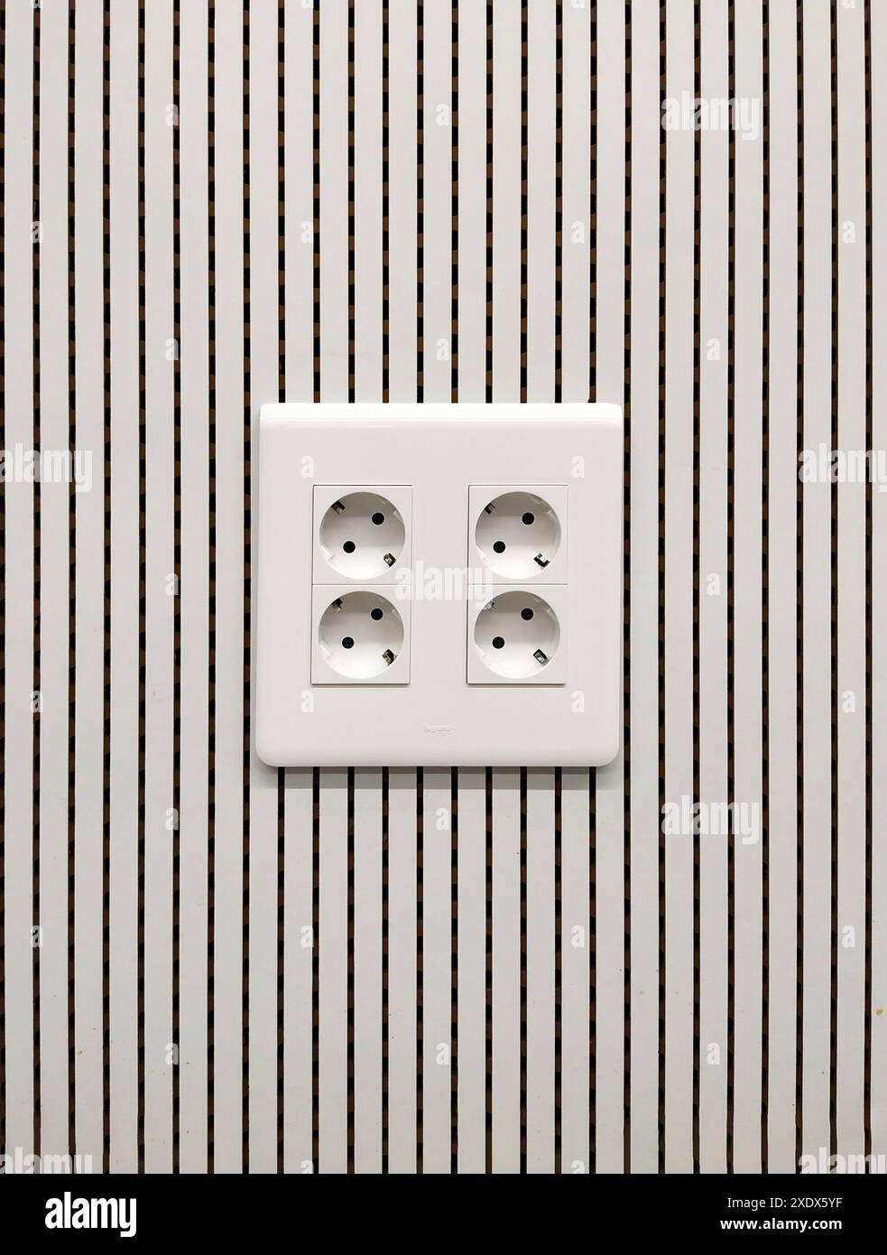 Quad socket on a wall with vertical lines paper Stock Photo - Alamy