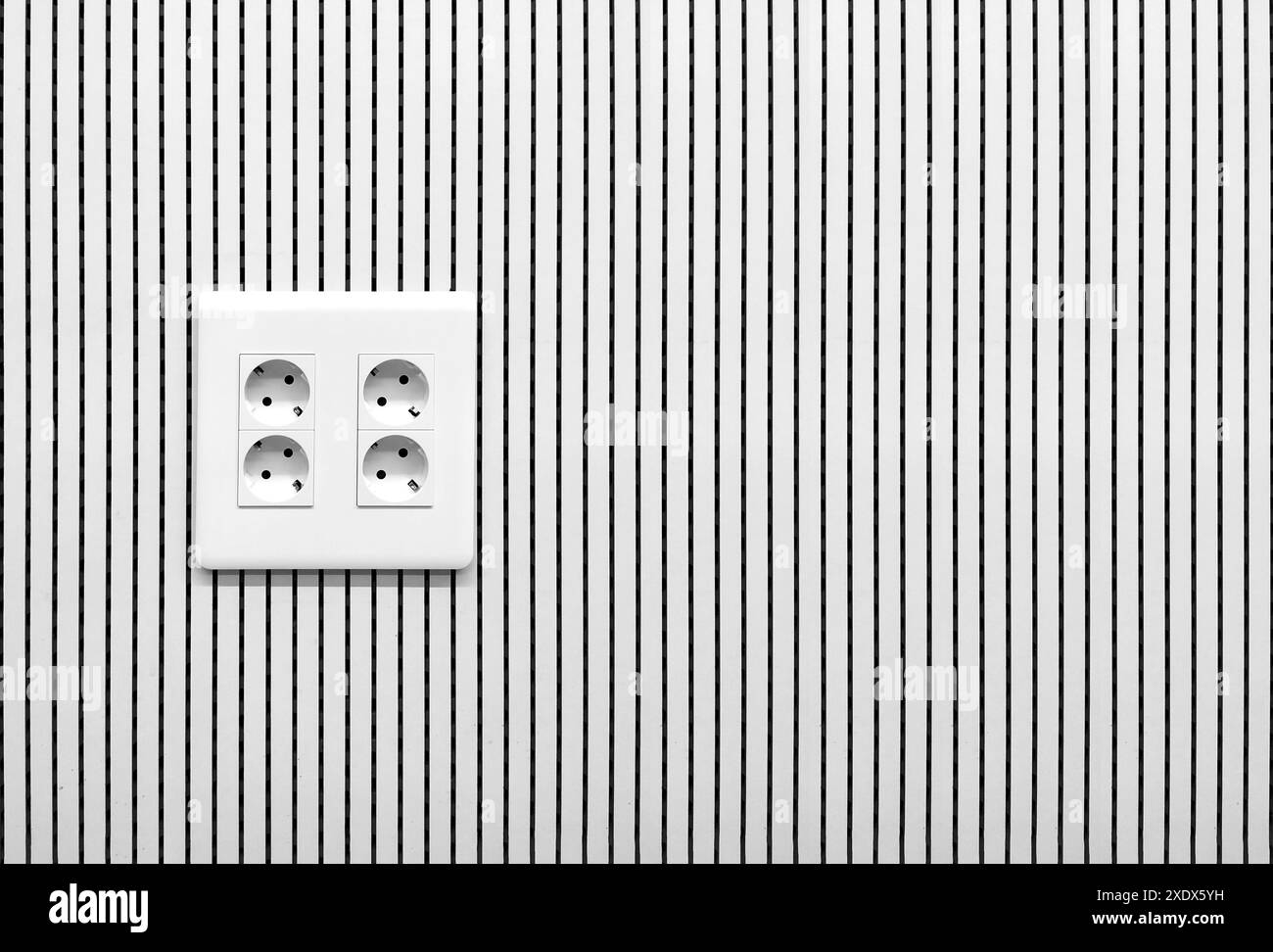 Quad socket on a wall with vertical lines paper Stock Photo - Alamy