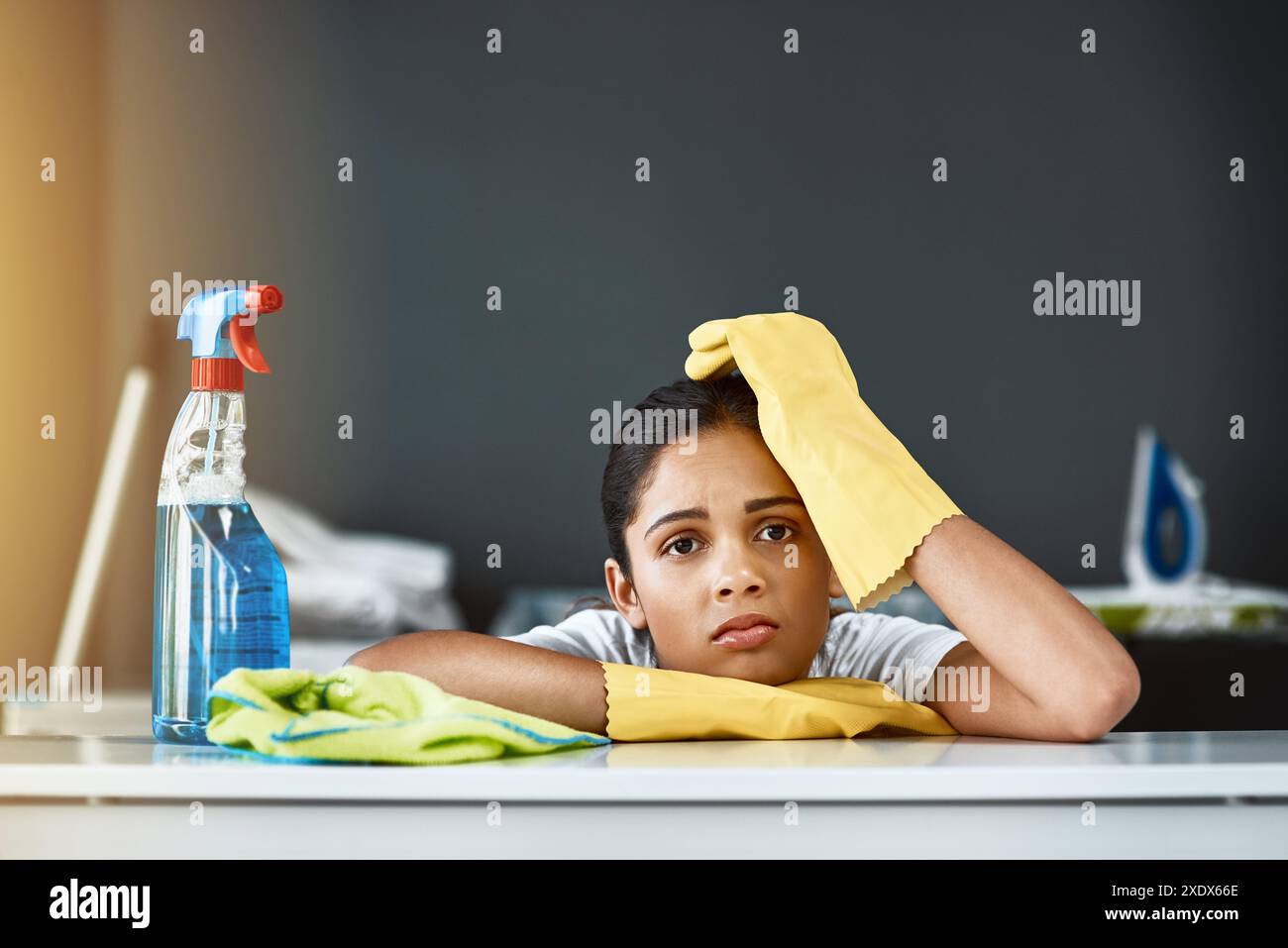 Portrait, woman and bored of cleaning in home with weekend chores ...