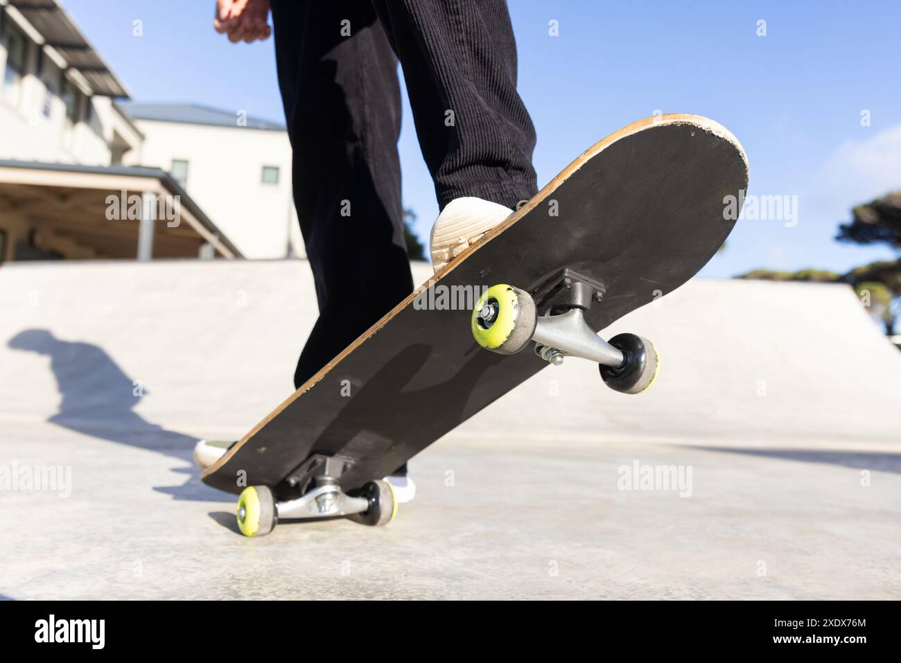 Balancing on skateboard, male student skateboarding at skatepark ...