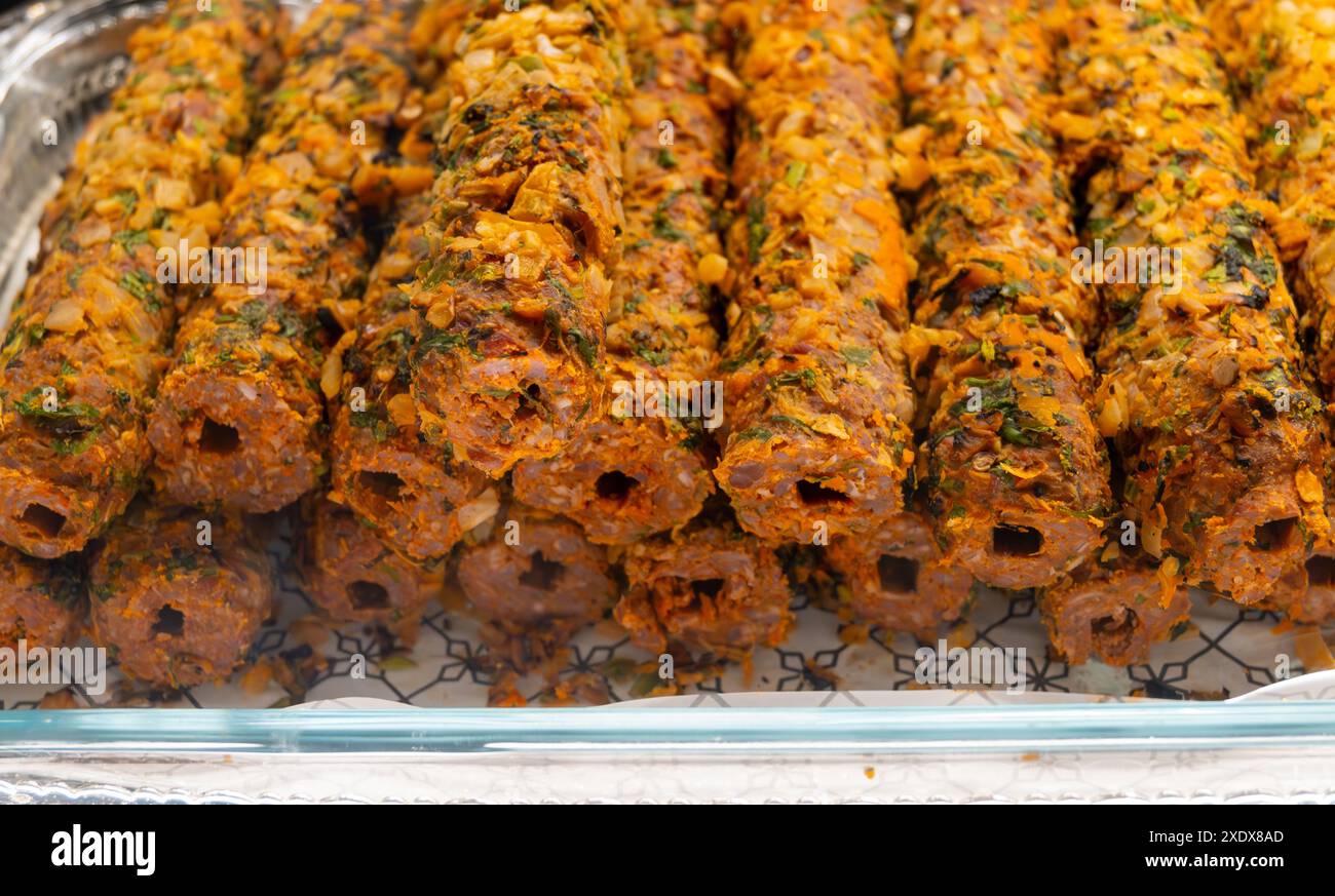 Lamb seekh kebabs meat food ready to cook on charcoal grill on display ...